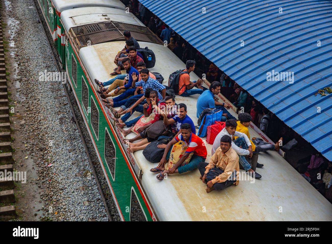 An overcrowded train leaves the Airport Railway Station in Dhaka ahead ...