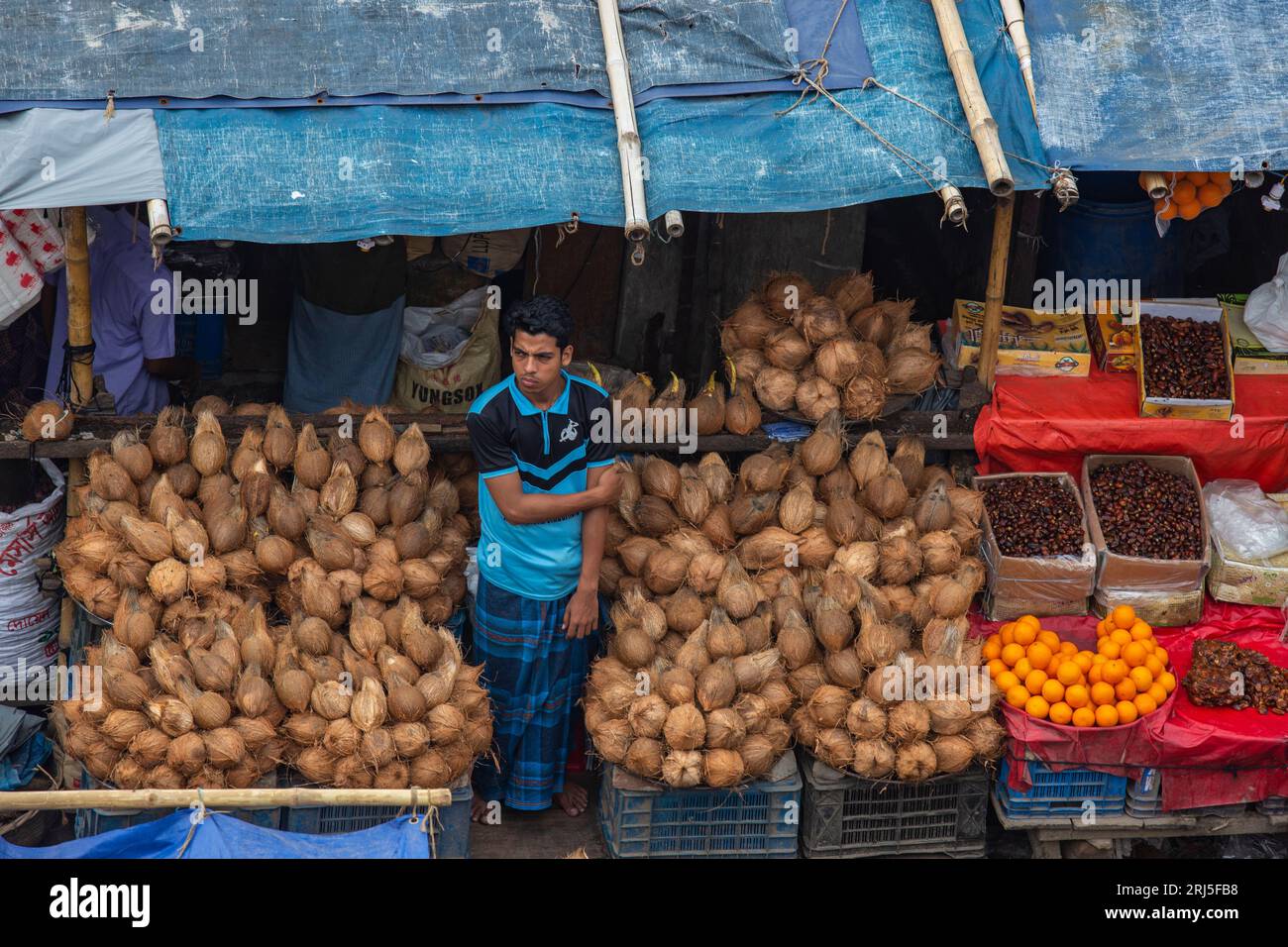 Coconut seller at the Jurain Railgate Market where around 600 hawkers ...