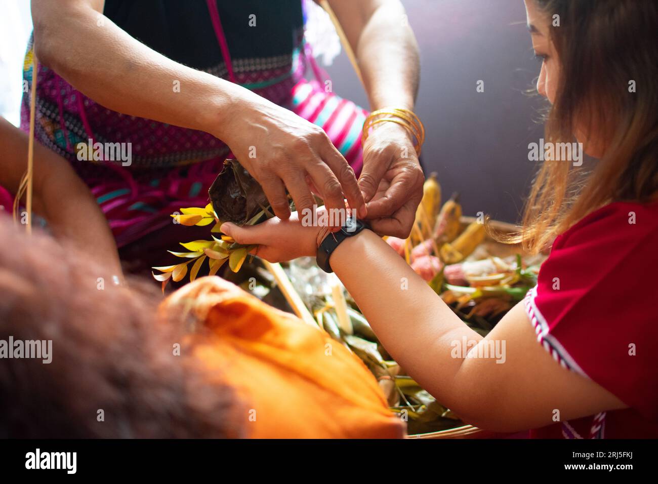 Karen traditional wrist tying ceremony: Tying white and red cotton ...