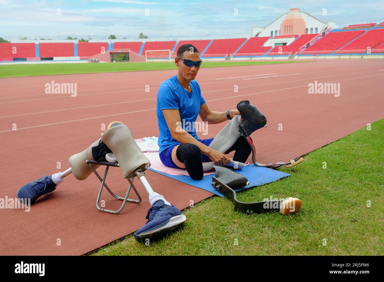 An Asian paralympic athlete equipped with prosthetic running blades ...