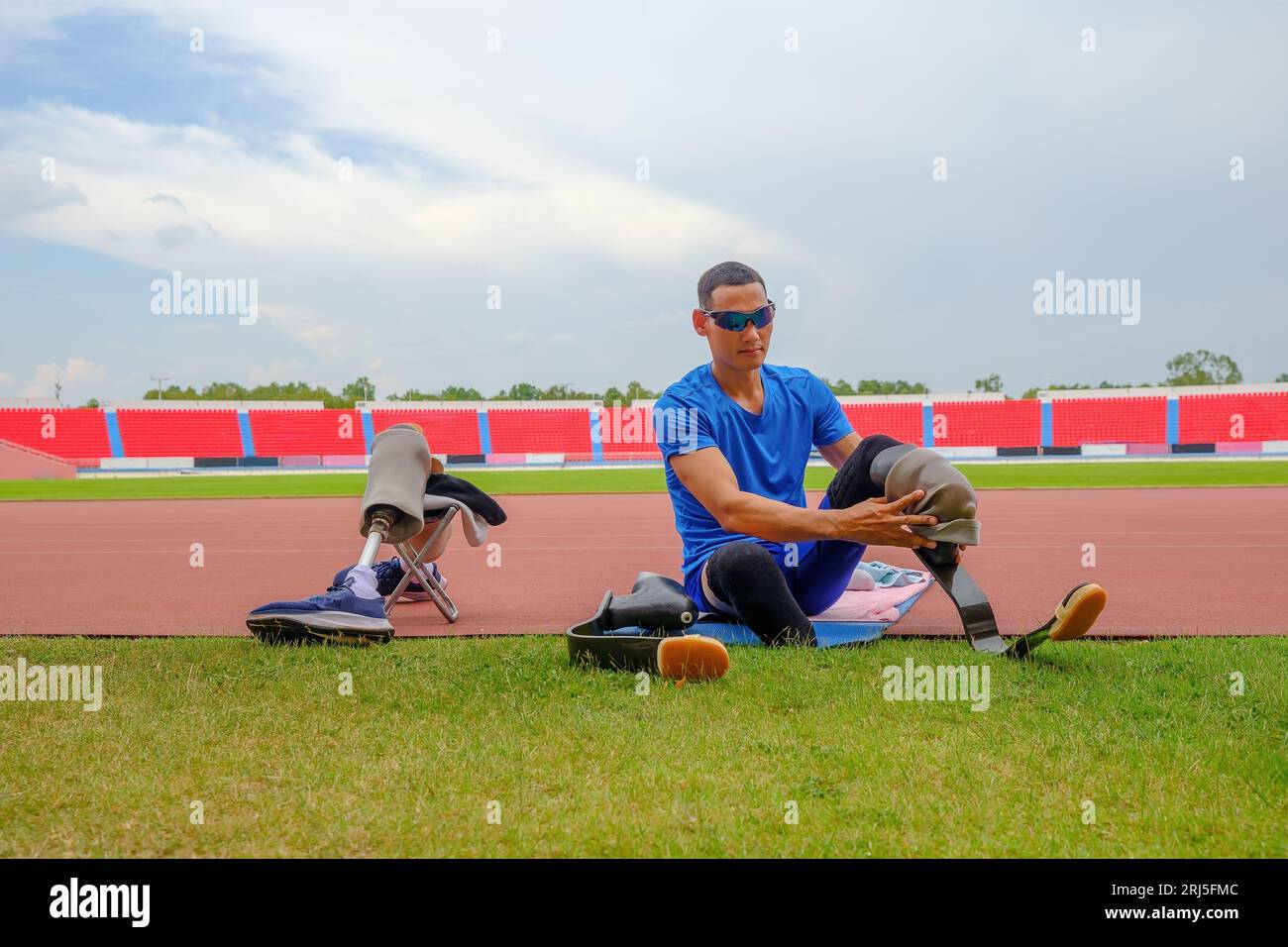 An Asian paralympic athlete equipped with prosthetic running blades ...