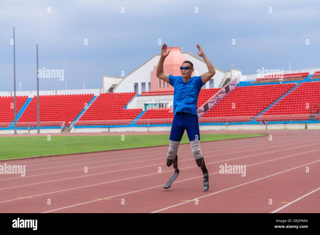 An Asian paralympic athlete equipped with prosthetic running blades ...