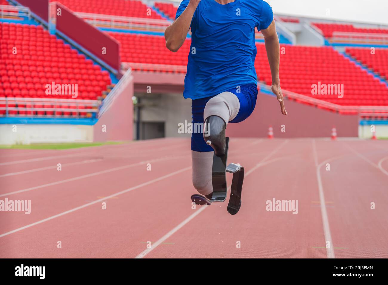 An Asian paralympic athlete equipped with prosthetic running blades ...