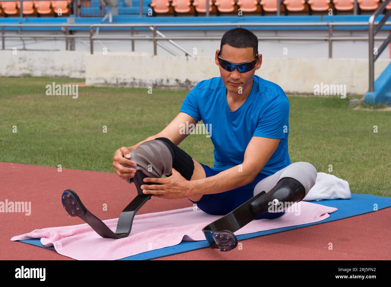 An Asian paralympic athlete equipped with prosthetic running blades ...