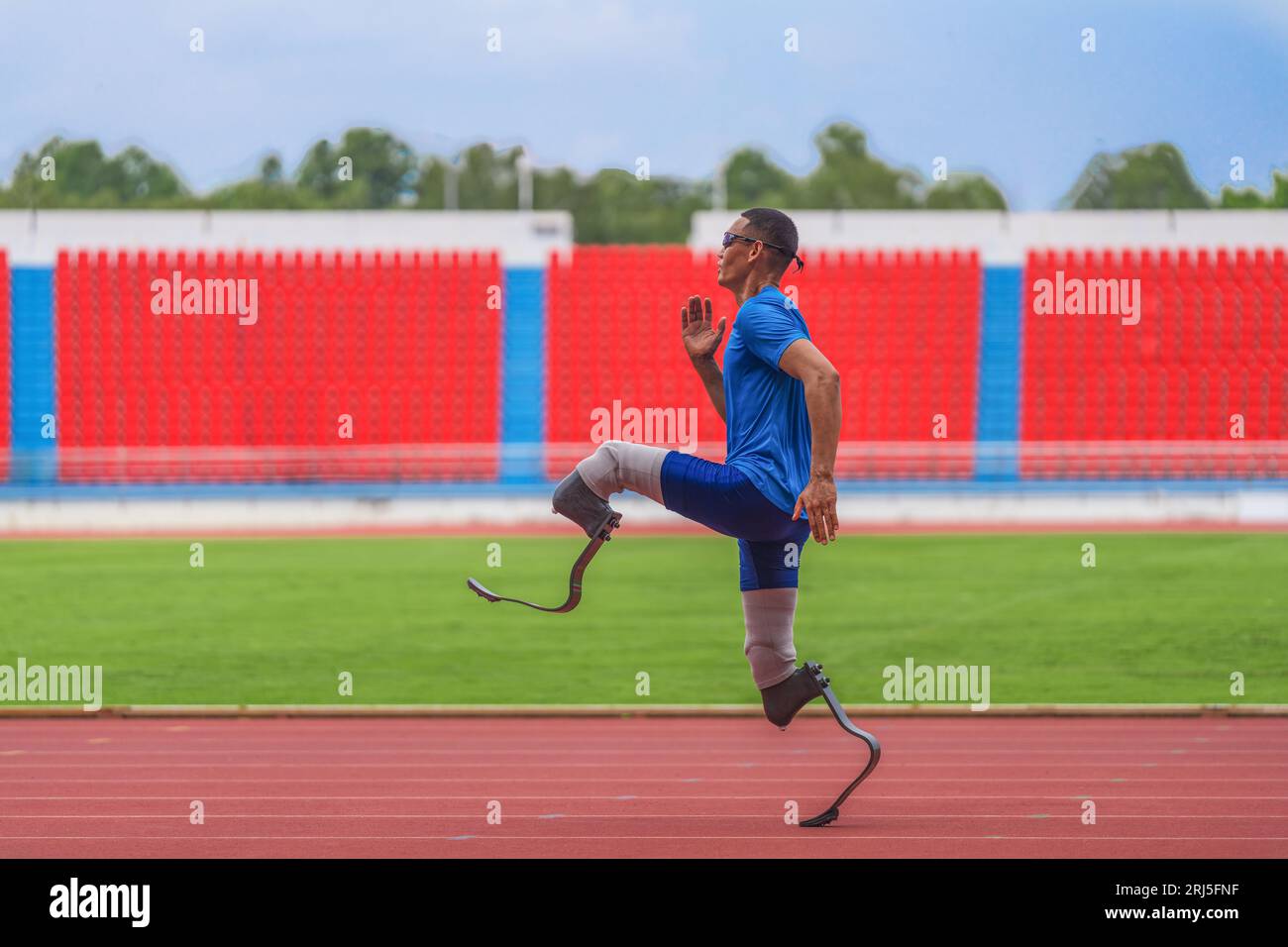 An Asian paralympic athlete equipped with prosthetic running blades ...