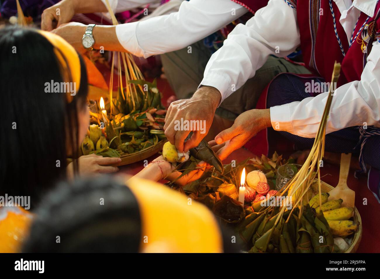 Karen traditional wrist tying ceremony: Tying white and red cotton ...