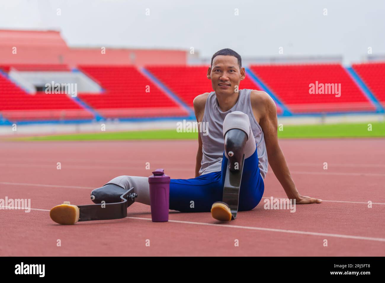 An Asian paralympic athlete equipped with prosthetic running blades ...