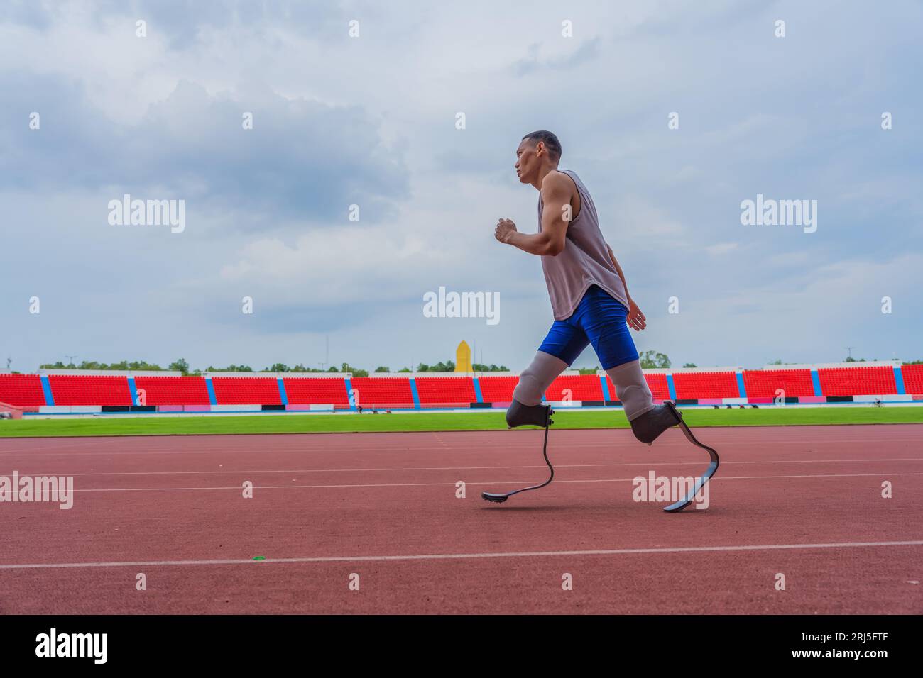An Asian paralympic athlete equipped with prosthetic running blades ...