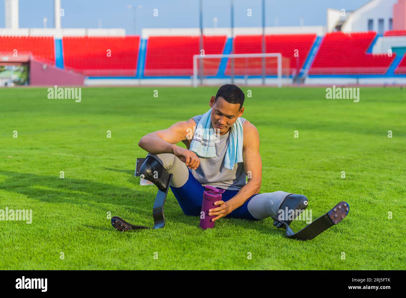 An Asian paralympic athlete equipped with prosthetic running blades ...