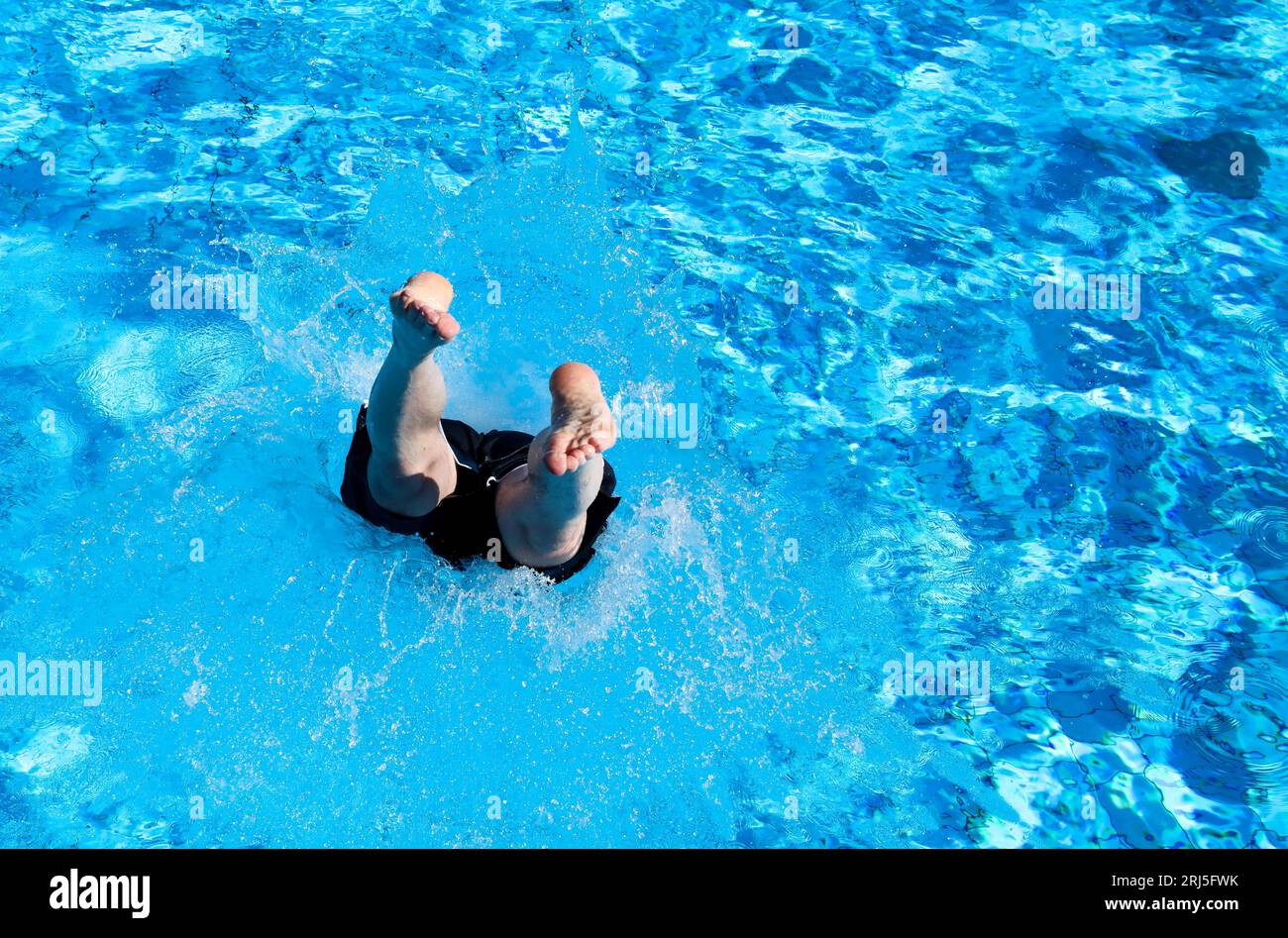 Mengen, Germany. 21st Aug, 2023. A man jumps into the water from a ...
