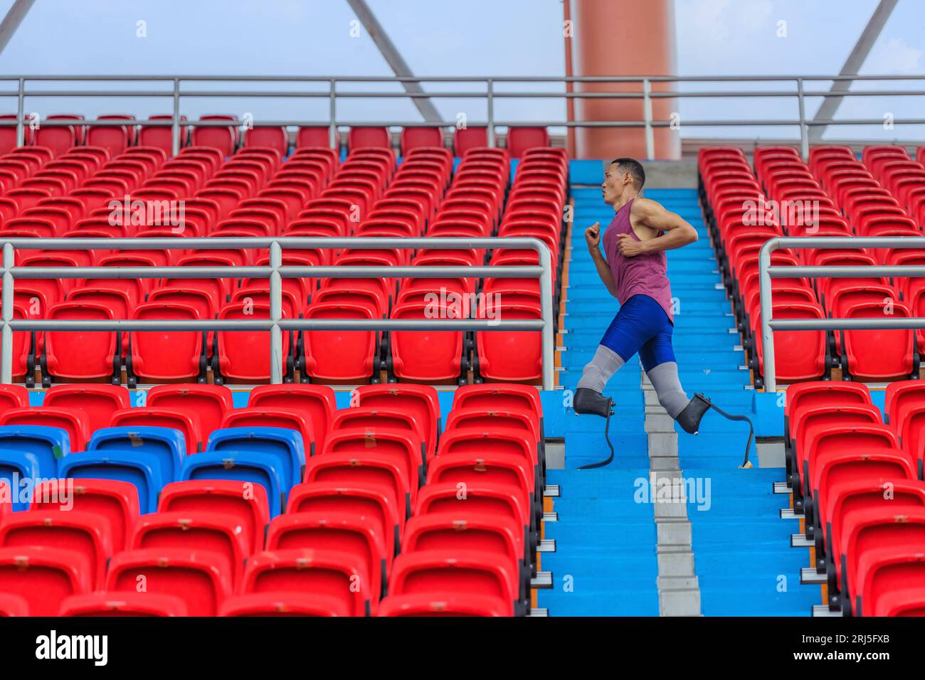An Asian paralympic athlete equipped with prosthetic running blades ...