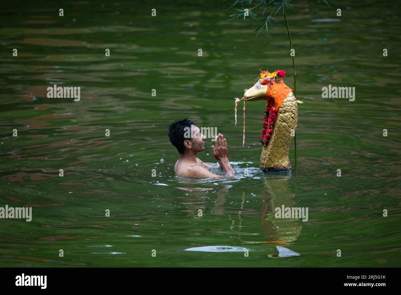 Bhaktapur, Nepal. 21st Aug, 2023. A Hindu devotee pays his respect to a ...
