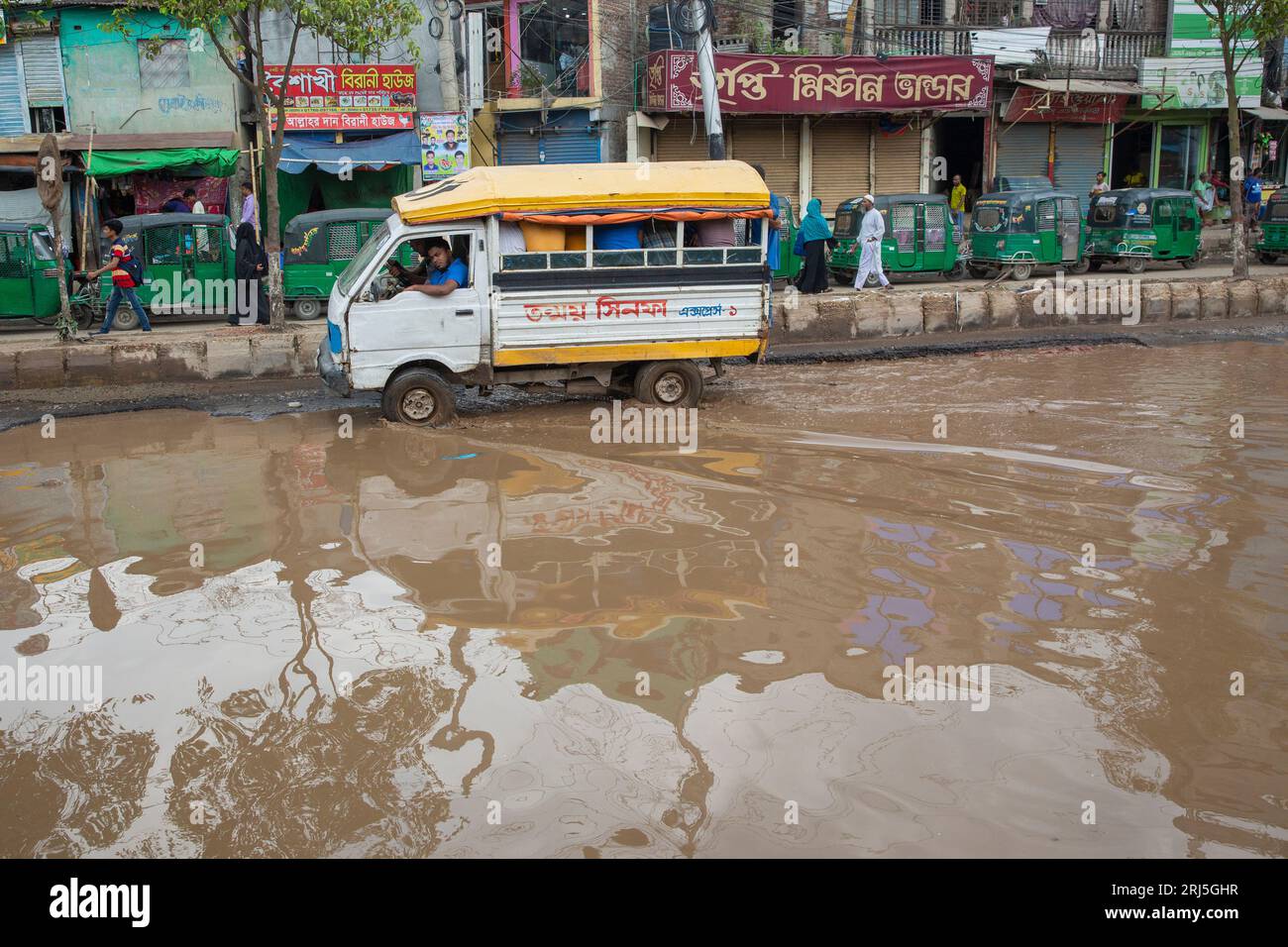 A human howler on a submerged road at Jurain in Dhaka, Bangladesh Stock ...