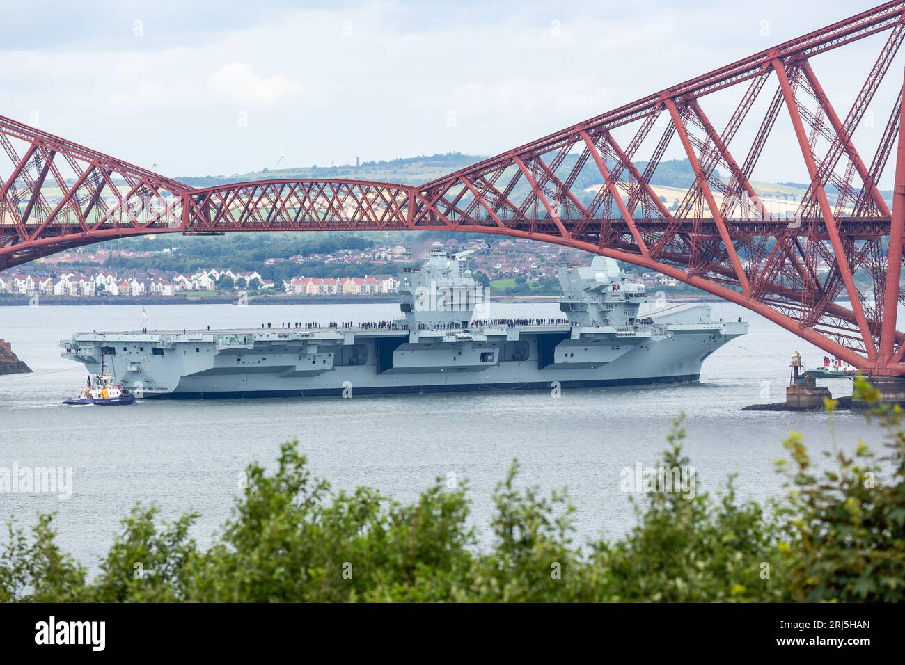 Aircraft Carrier HMS Prince Of Wales leaving the Port of Rosyth and Sailing under the Forth ...