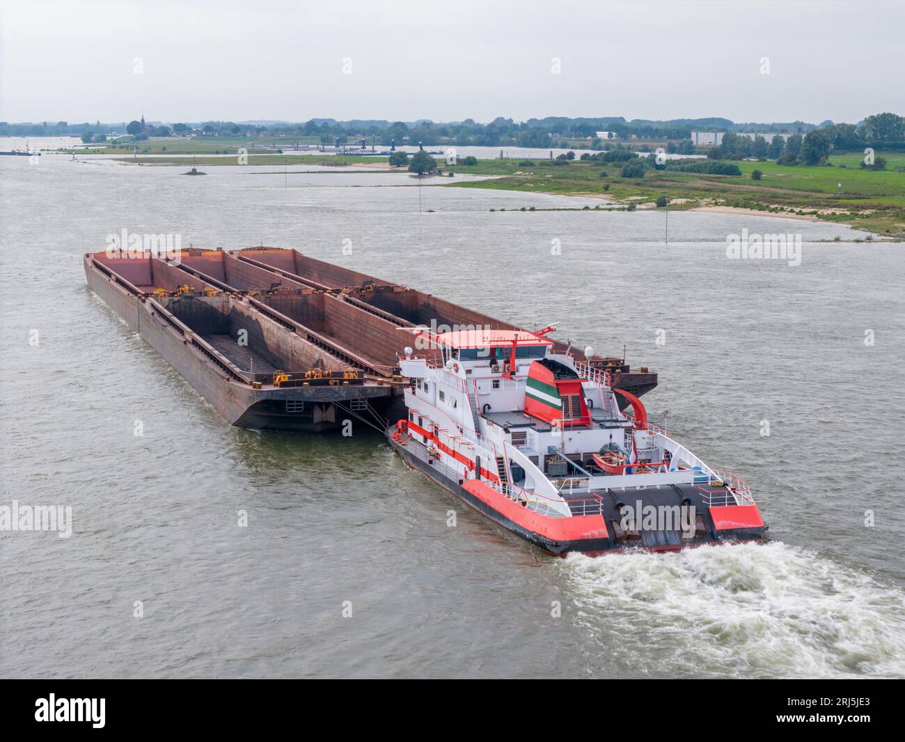 Aerial drone photo of a large cargo barge sailing on the river Waal in ...