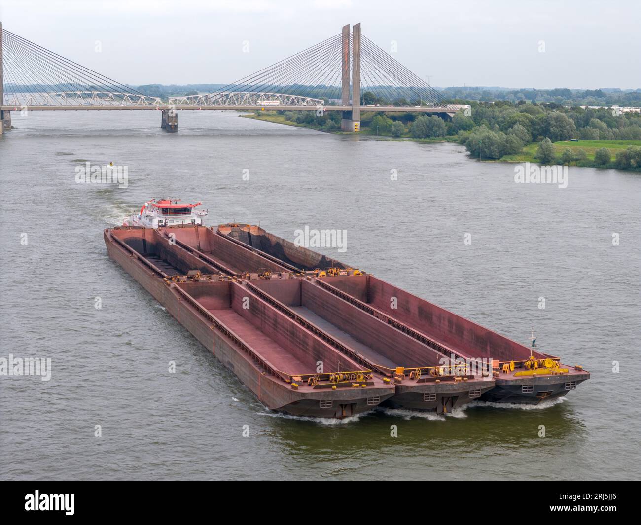 Aerial drone photo of a large cargo barge sailing on the river Waal in ...