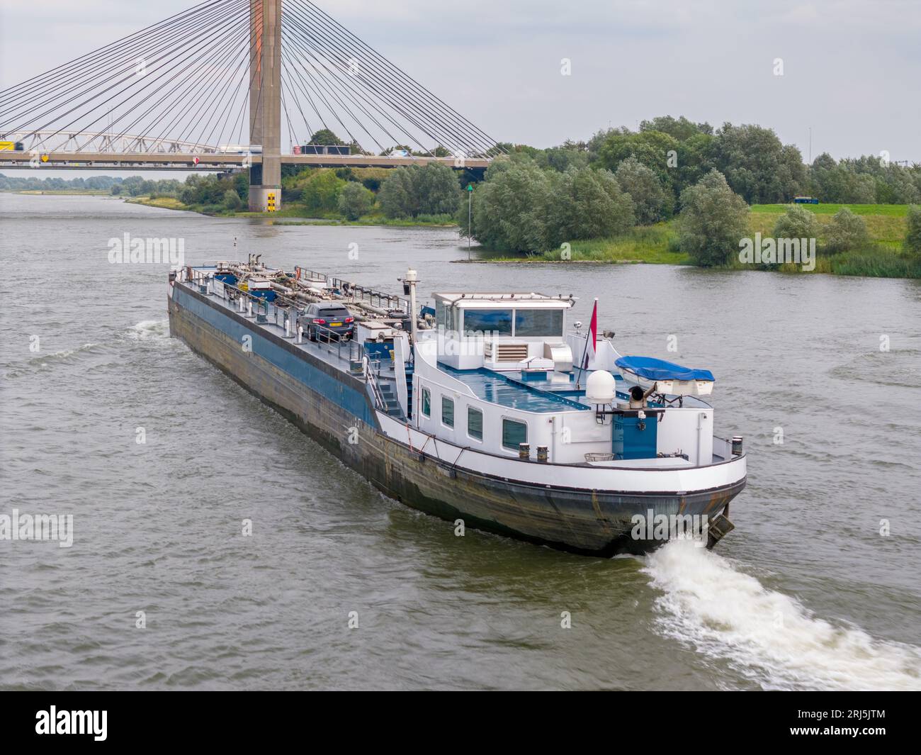 Aerial drone photo of a large cargo barge sailing on the river Waal in ...