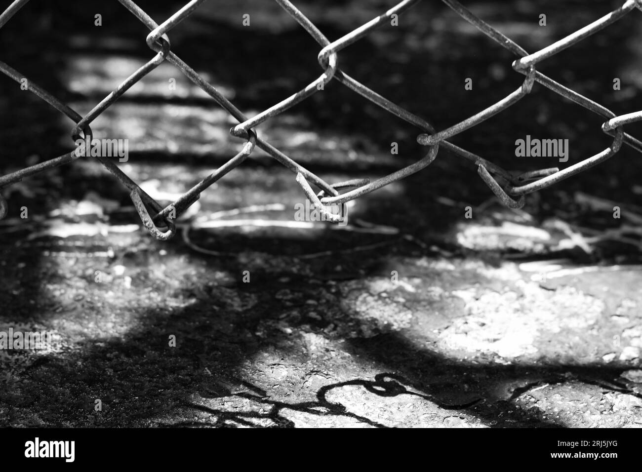 Industrial metal chain link fence with a typical repeating pattern in a ...