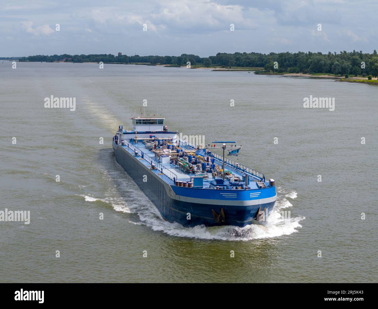 Aerial drone photo of a large cargo barge sailing on the river Waal in ...