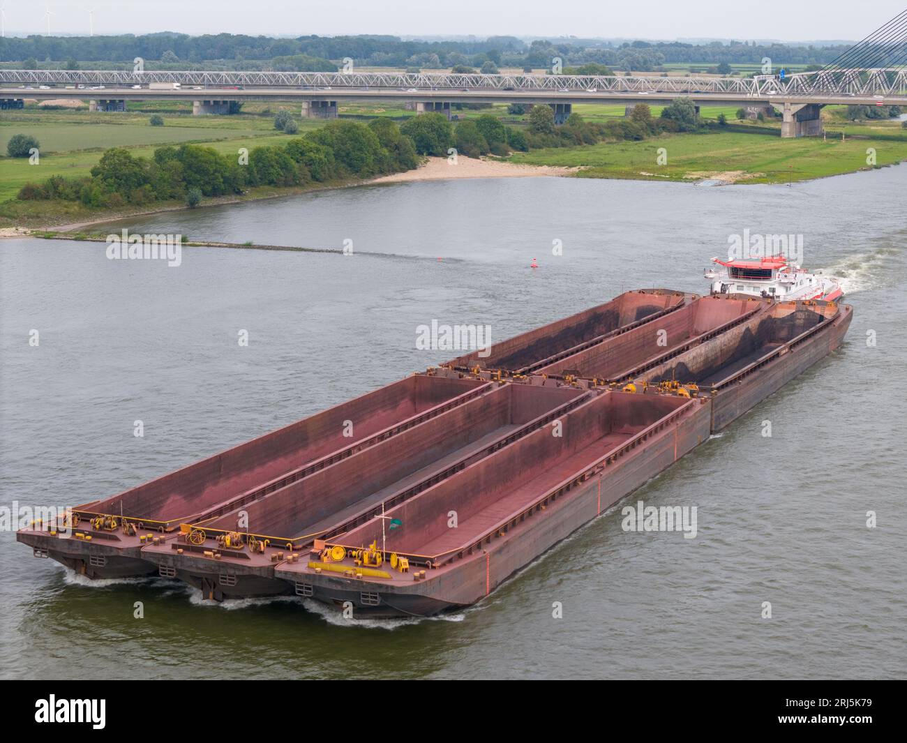 Aerial drone photo of a large cargo barge sailing on the river Waal in ...