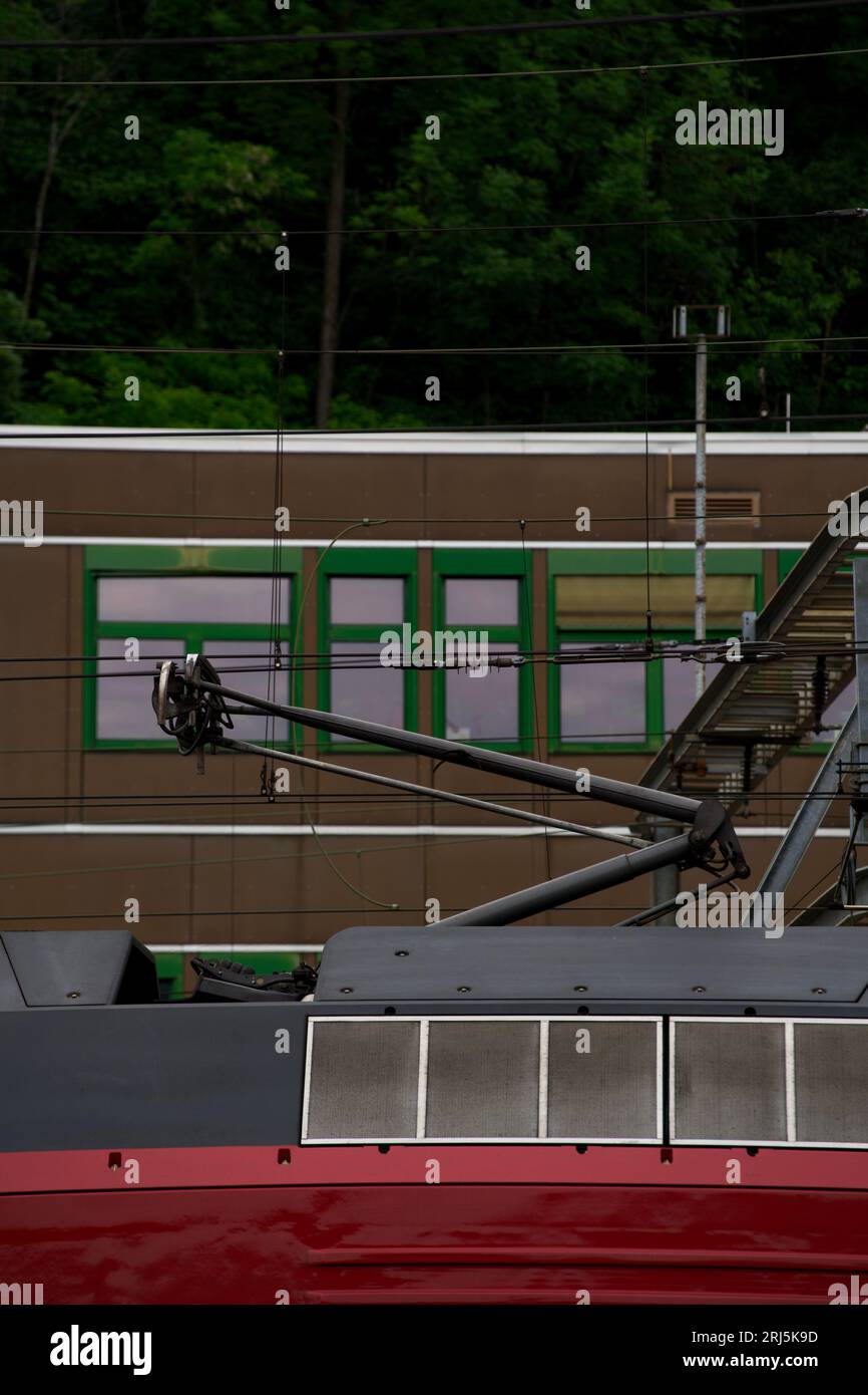 A vertical view of cables of an electrical red train Stock Photo - Alamy