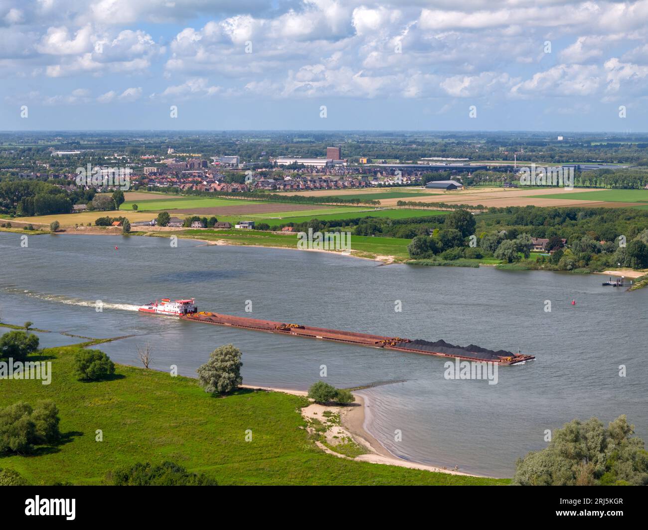 Aerial drone photo of a large cargo barge sailing on the river Waal in ...