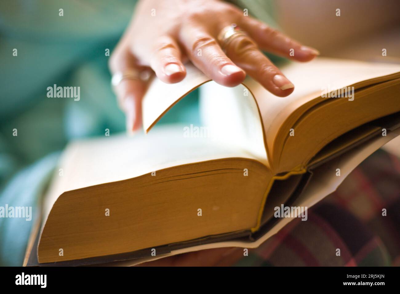 A close-up of a woman turning the book pages over Stock Photo - Alamy