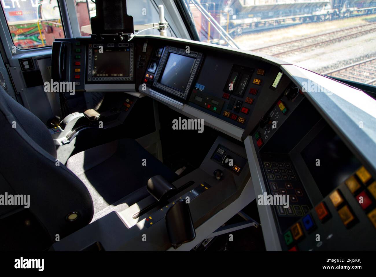 A modern train control panel with illuminated buttons in a dimly lit ...