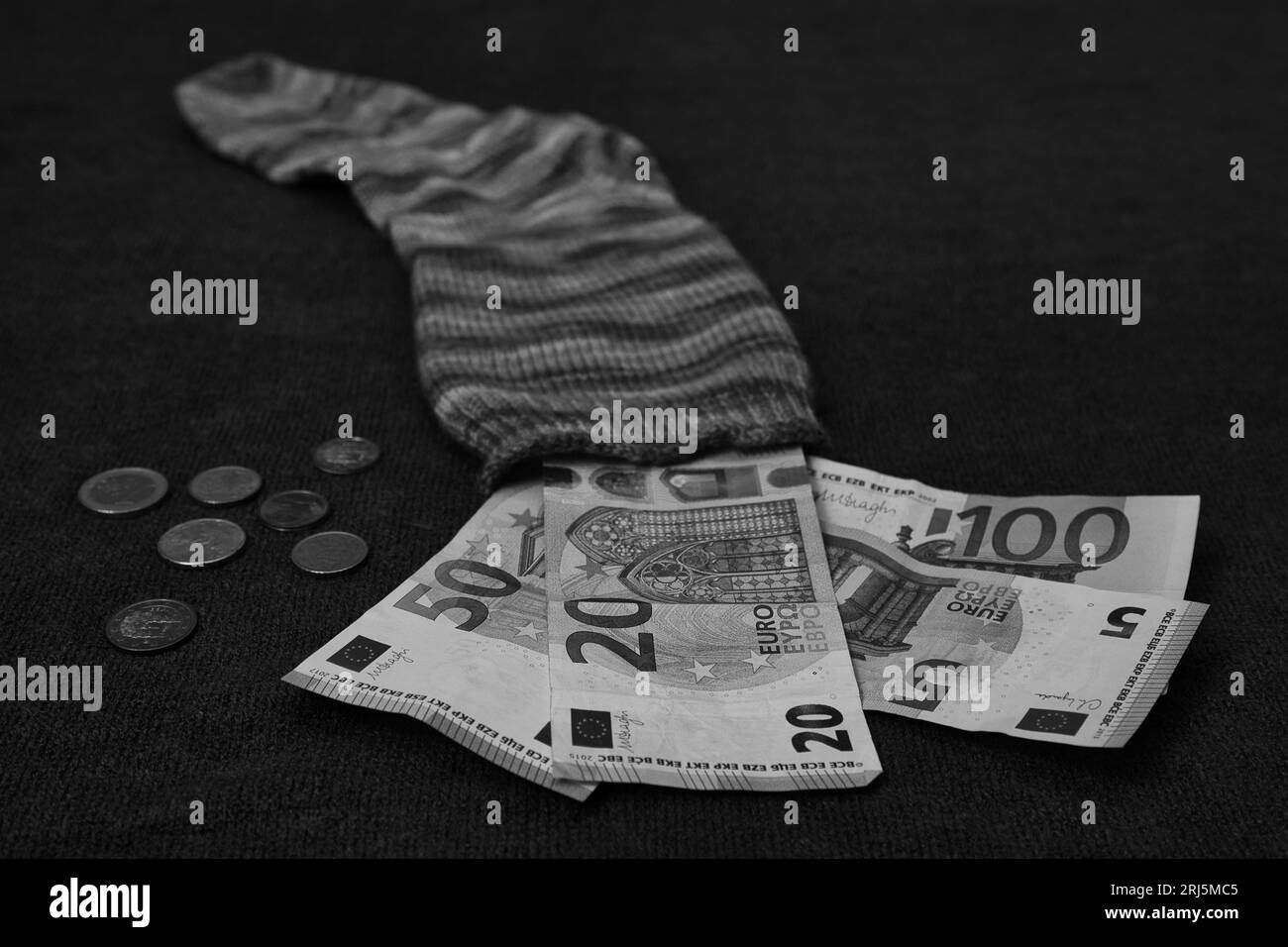 Money from savings stockings and coins as a symbol of poverty, hardship ...