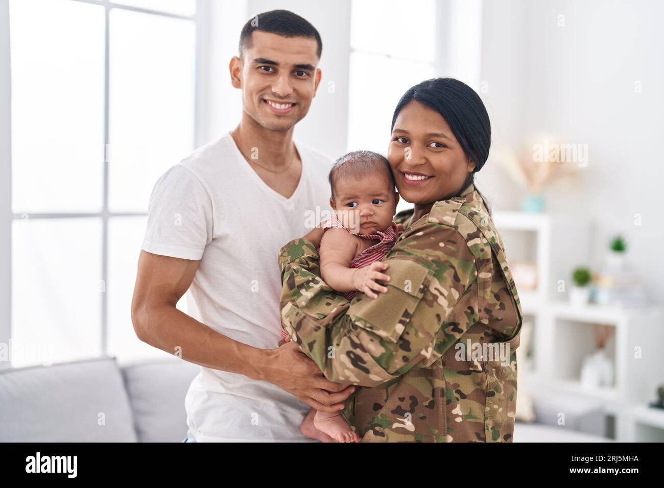 Hispanic family army soldier hugging each other at home Stock Photo - Alamy
