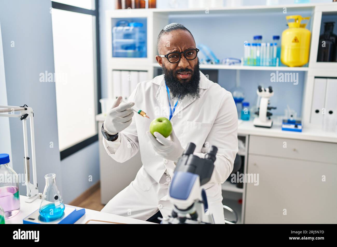 African american man working at scientist laboratory with apple ...