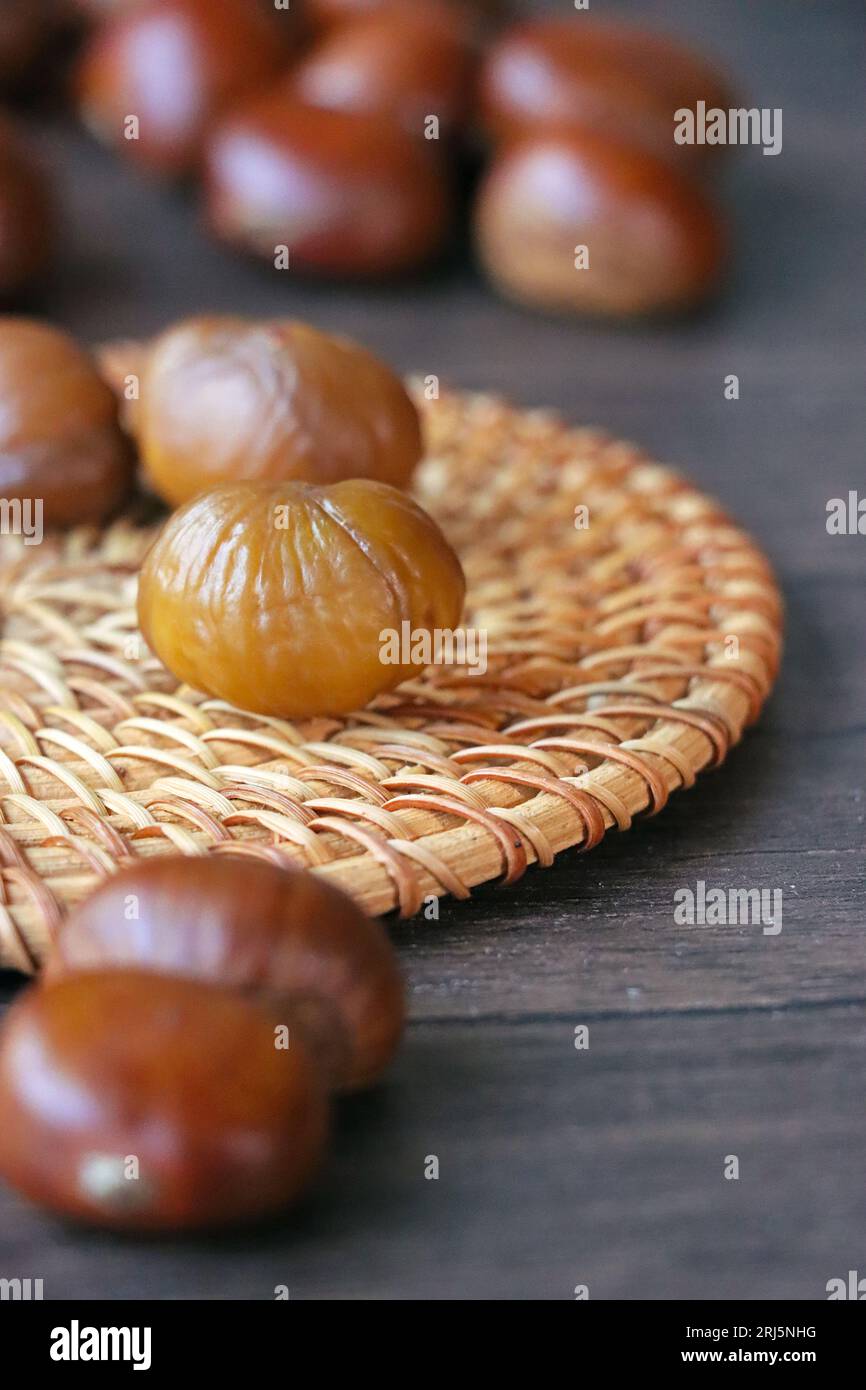 A vertical closeup of fried chestnuts, Chinese traditional snack Stock ...