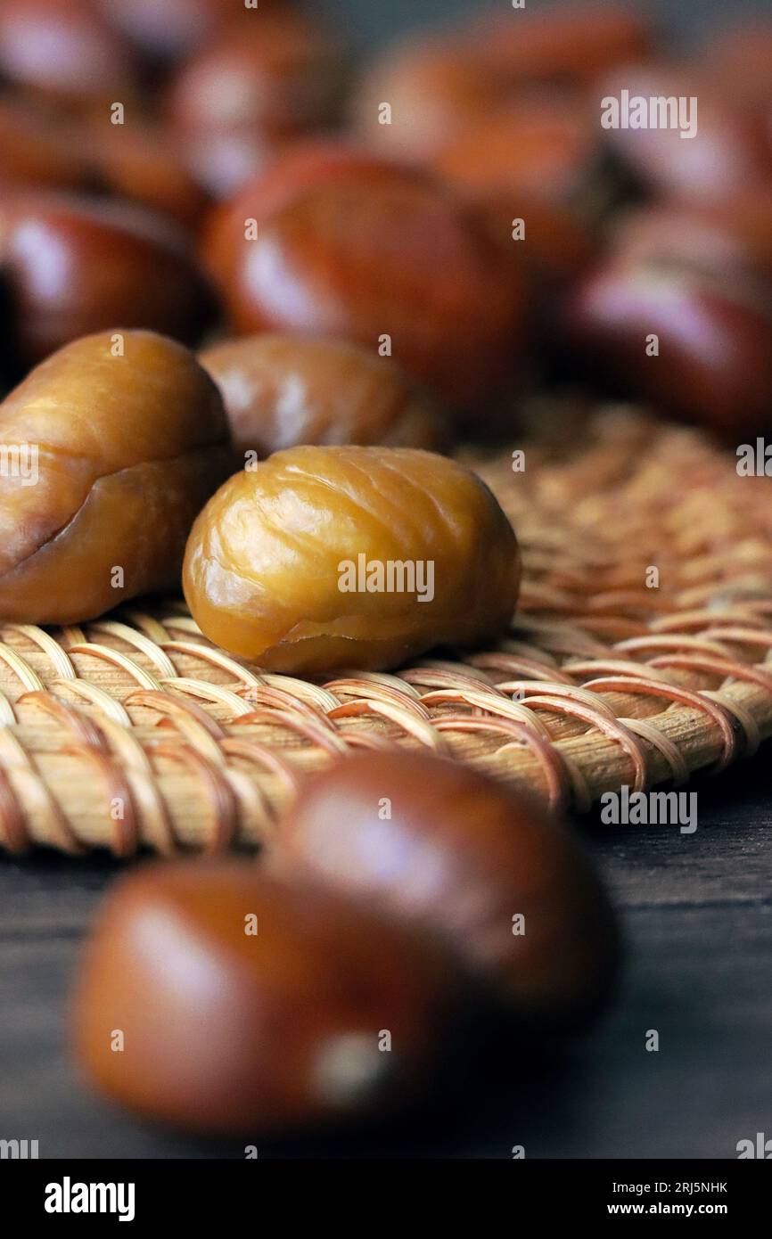 A vertical closeup of fried chestnuts, Chinese traditional snack Stock ...