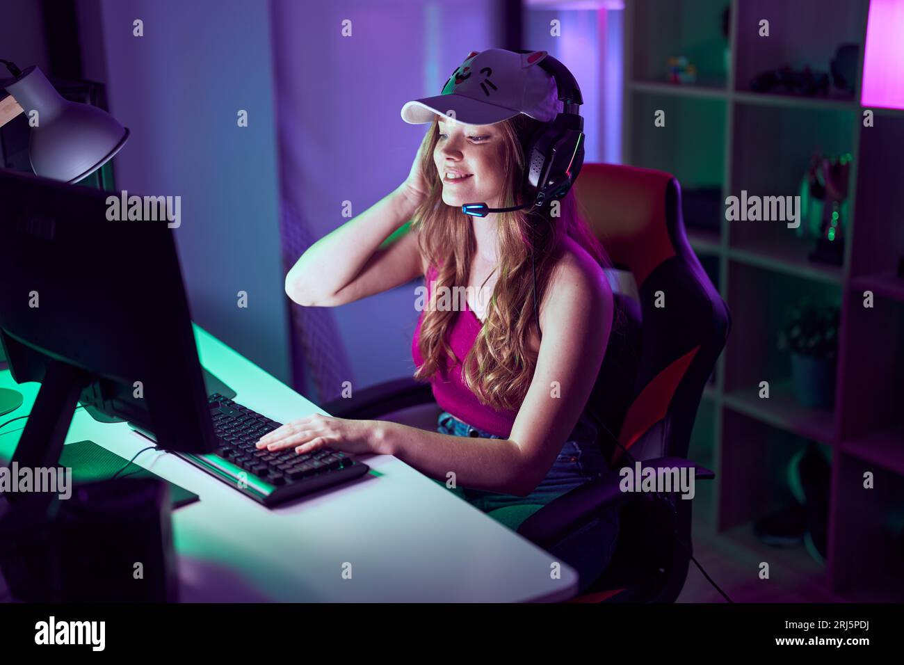 Young woman streamer using computer and headphones at gaming room Stock ...