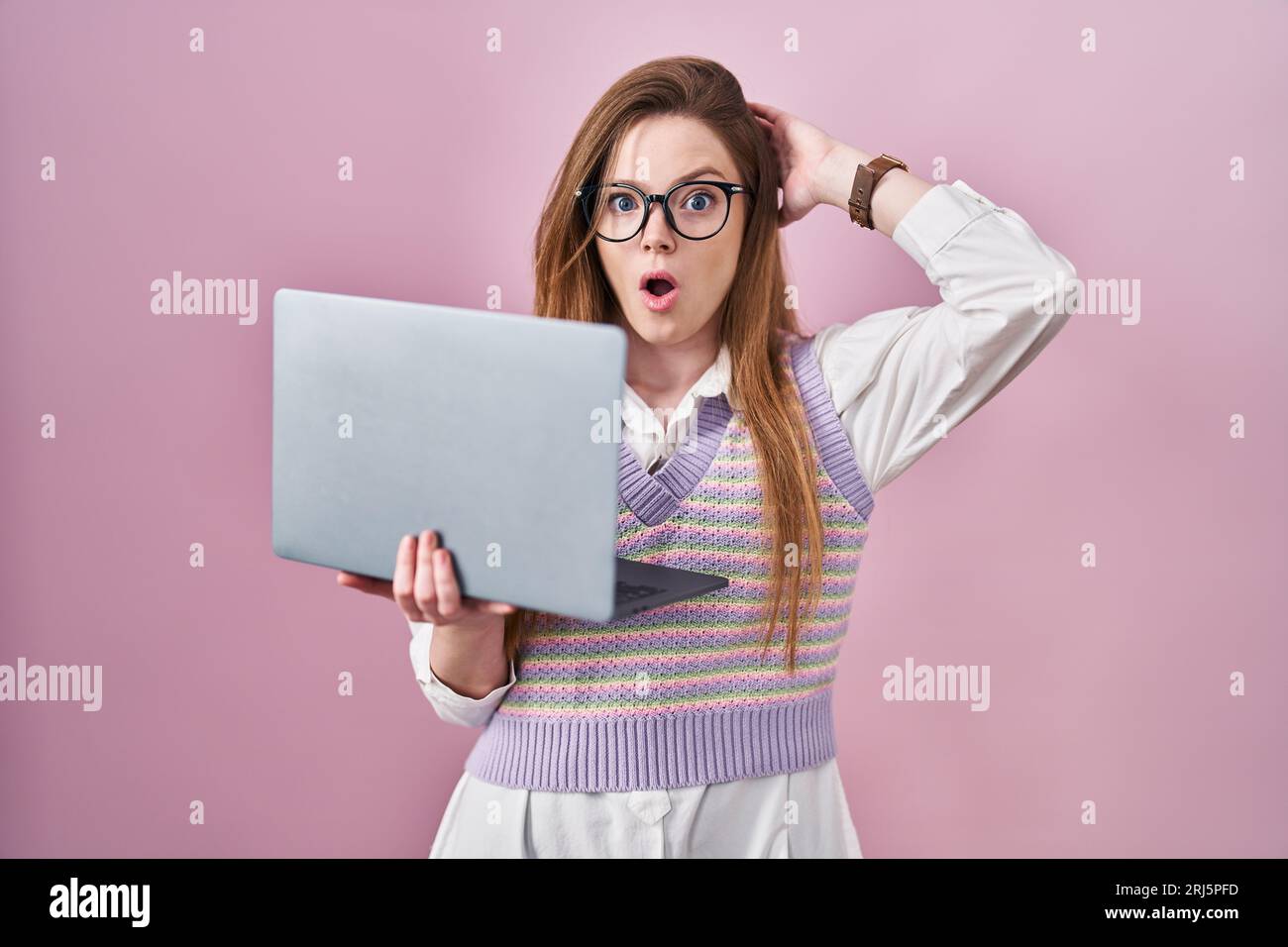 Young caucasian woman working using computer laptop crazy and scared ...