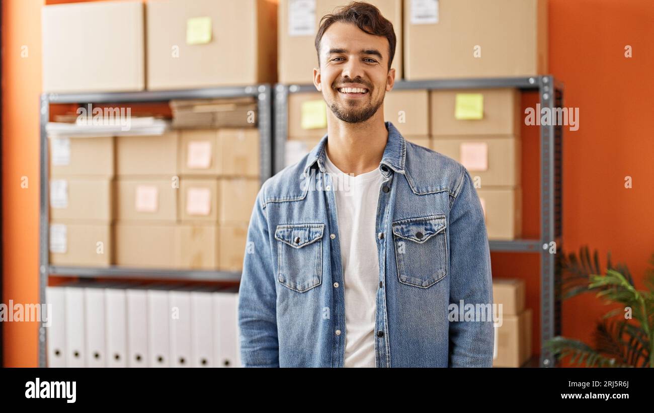 Young hispanic man ecommerce business worker smiling confident at ...