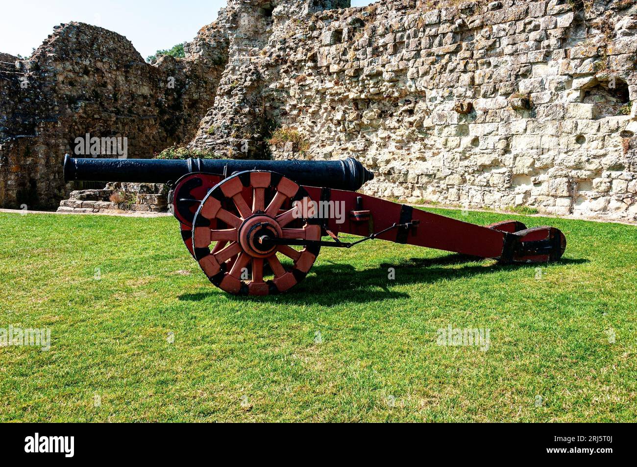 An ancient black cannon mounted on a two wheeled gun carriage with ...