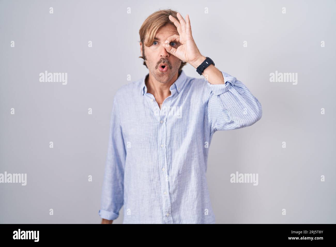 Caucasian man with mustache standing over white background doing ok ...