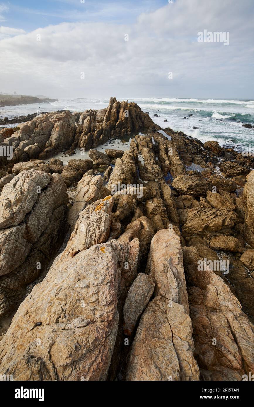 A scenic view of the cliffs with ocean waves in the background ...