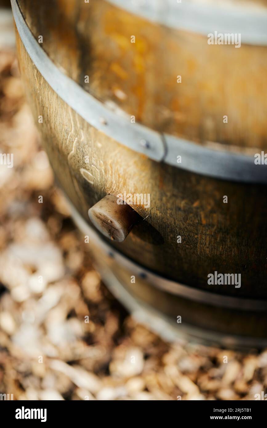 A close-up shot of a large barrel with a metal hoop around the top ...