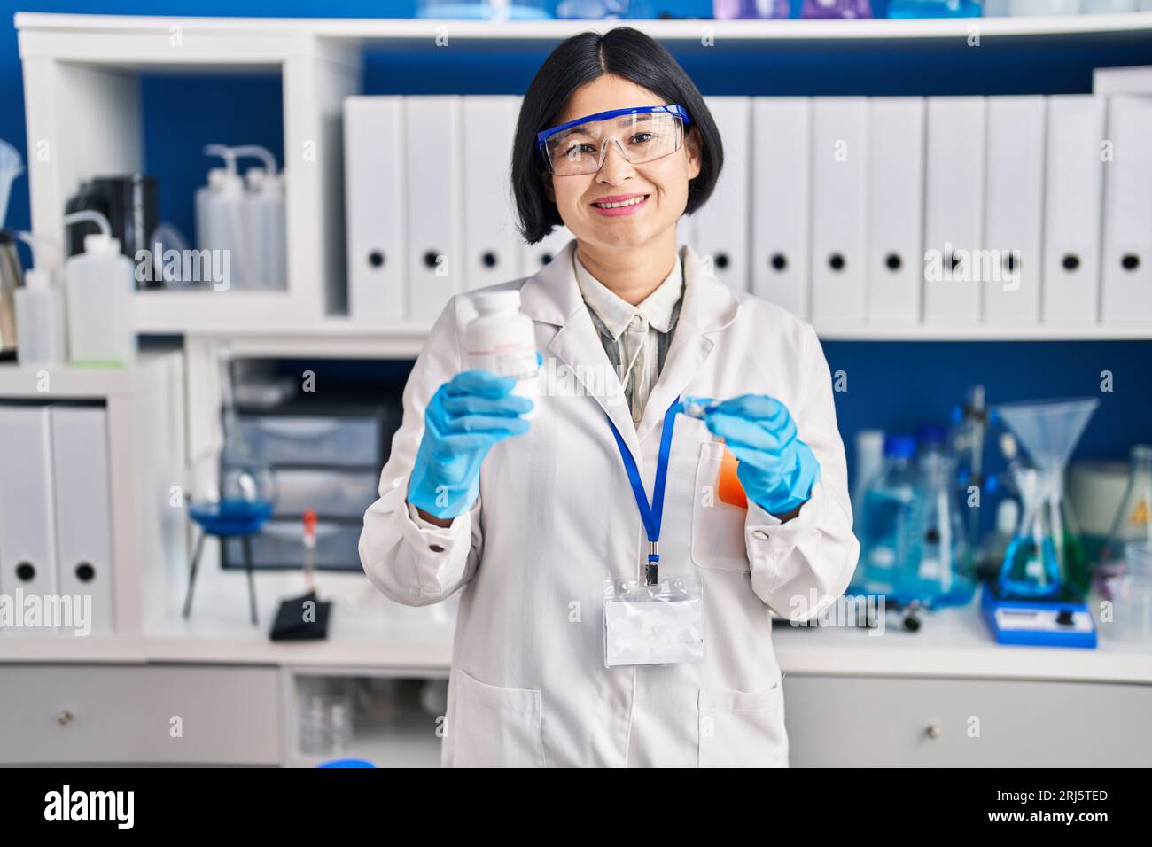 Young asian woman working at scientist laboratory smiling with a happy ...