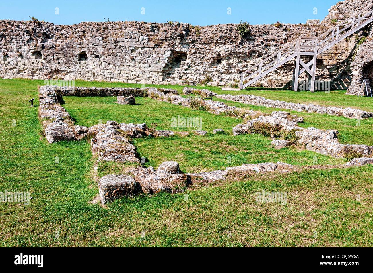 The stone foundations of the chapel at Pevensey Castle outline the ...