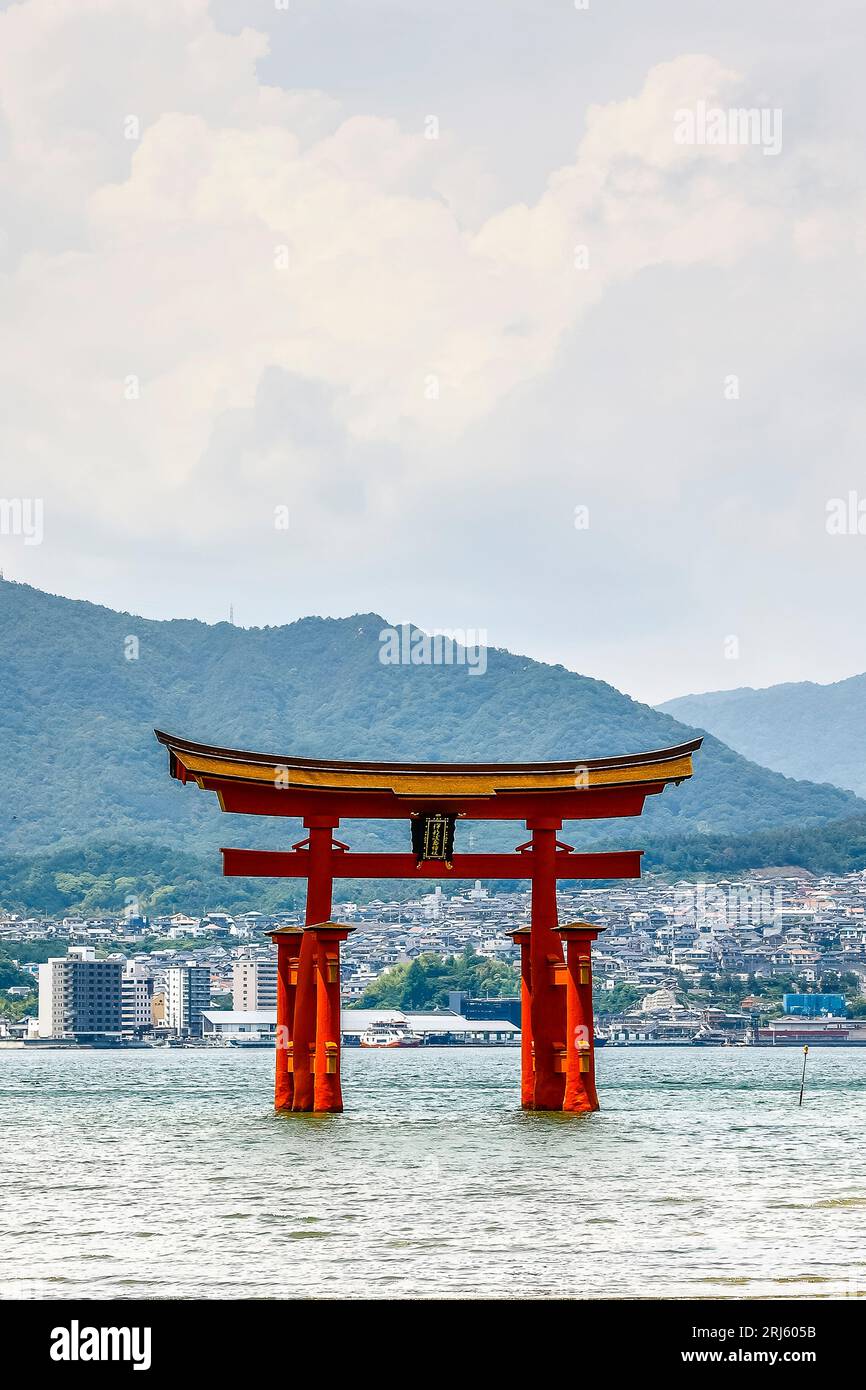 A gorgeous vertical view of the red, floating Torii gate of the ...