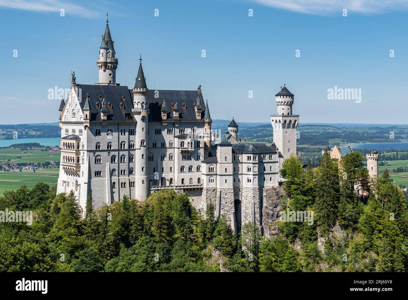 An aerial view of the historic Neuschwanstein Castle surrounded by lush ...