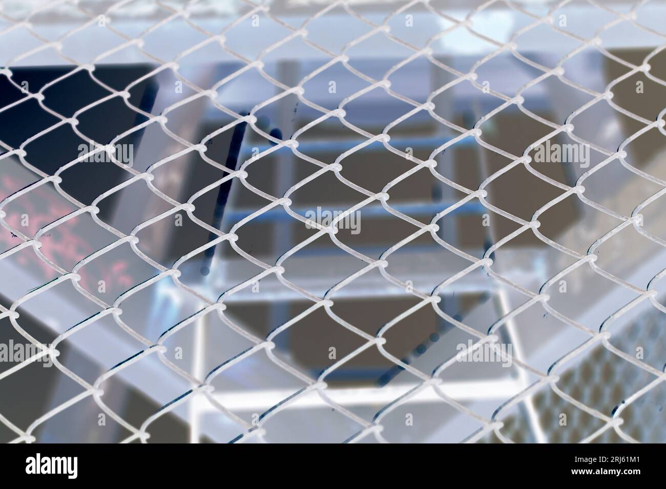 Industrial metal chain link fence with a typical repeating pattern in a ...