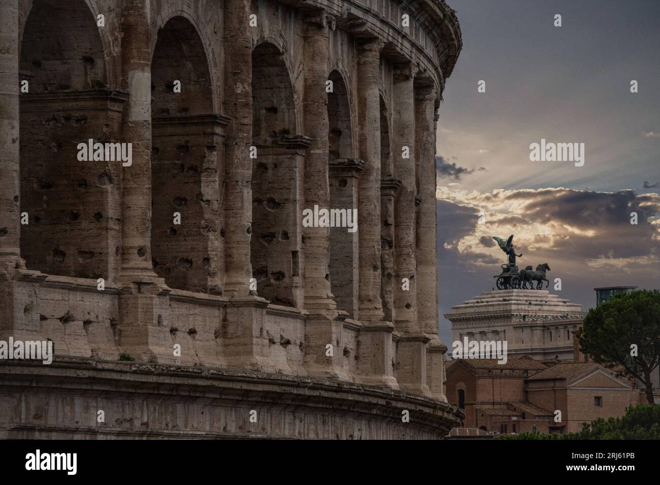 A beautiful view of the Colosseum exterior under a glowing sunset sky ...