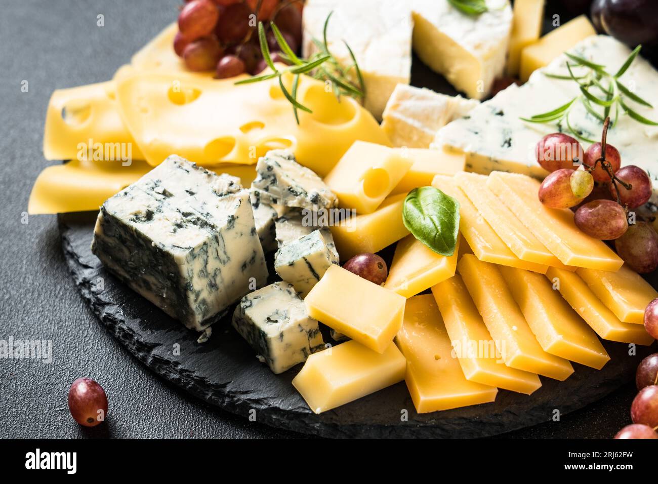 Cheese platter with craft cheese assortment on slate board Stock Photo ...