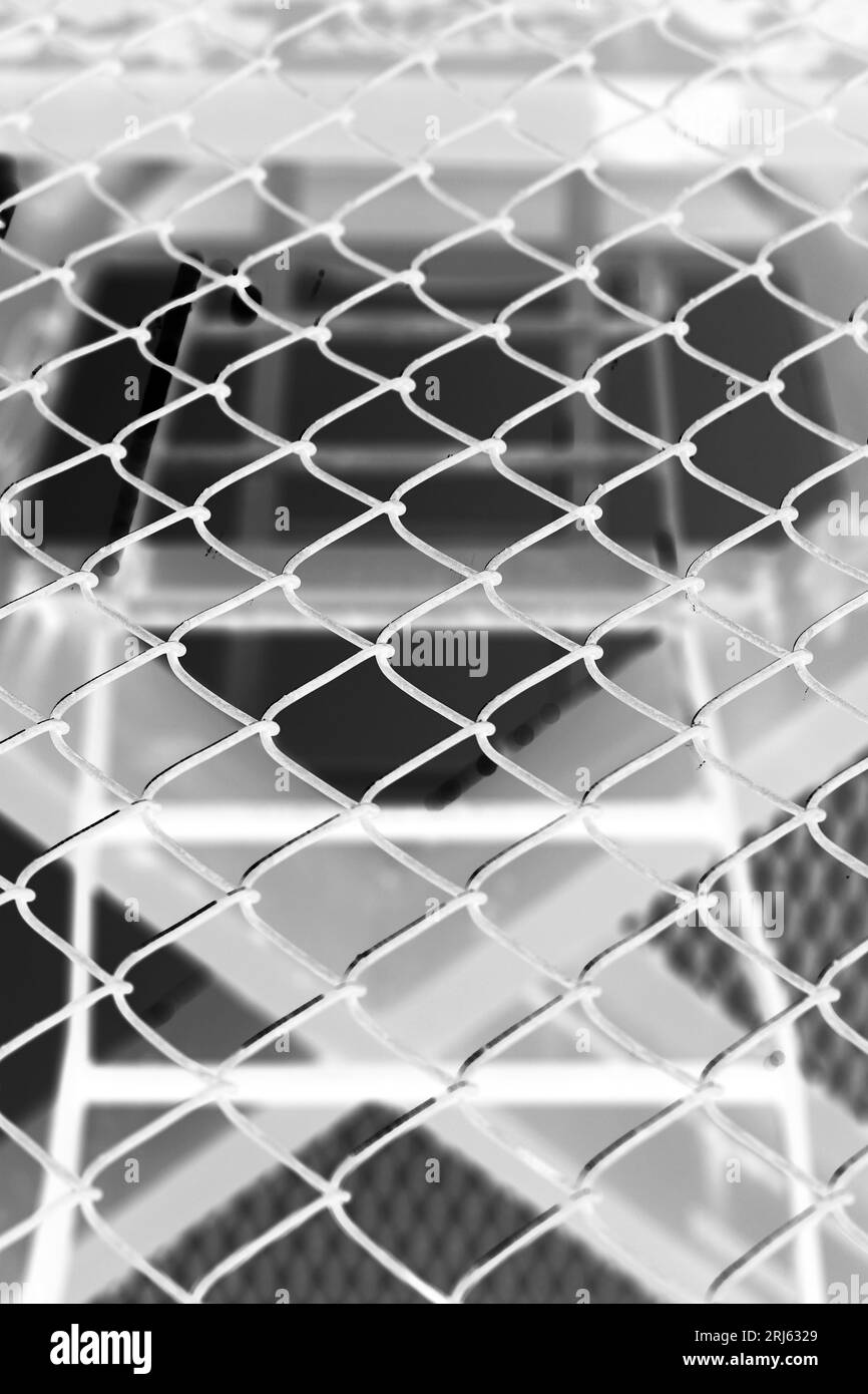 Industrial metal chain link fence with a typical repeating pattern in a ...