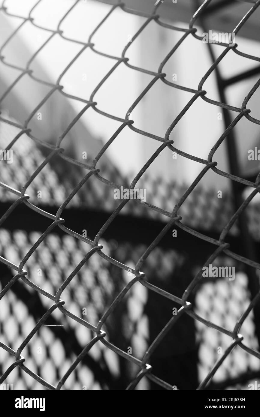 Industrial metal chain link fence with a typical repeating pattern in a ...