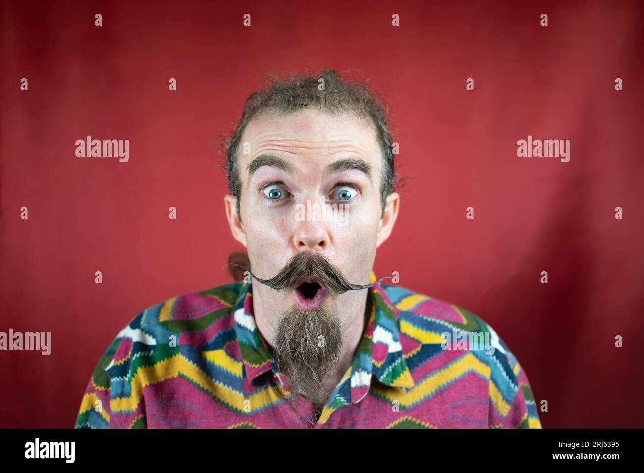 Hipster man with mustache, amazed, mouth open and shocked expression ...